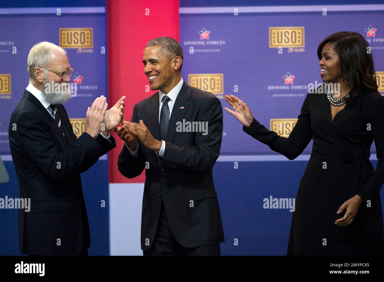 President Barack Obama and first lady Michelle Obama applaud along with ...
