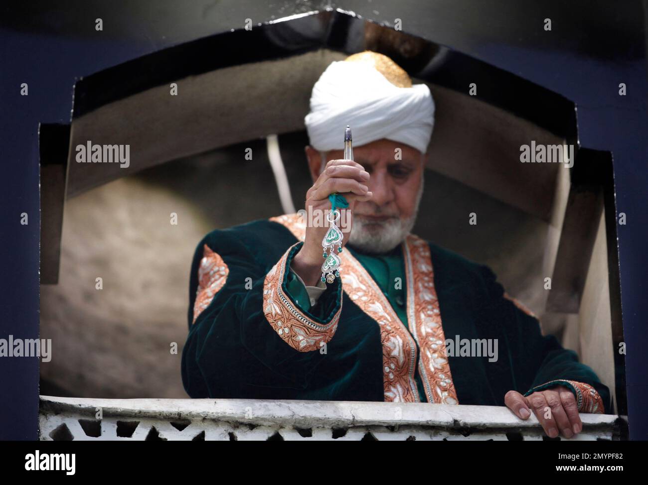 Mohammad Ishaq Banday, the head priest of Hazratbal shrine, displays a ...