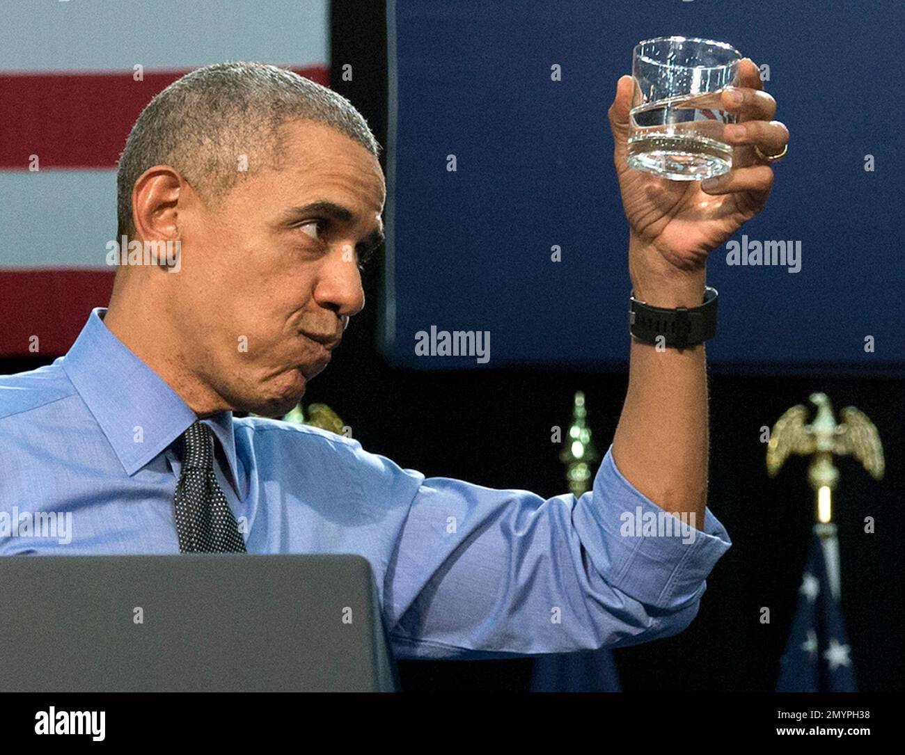 President Barack Obama holds up a glass of water as he drinks after ...