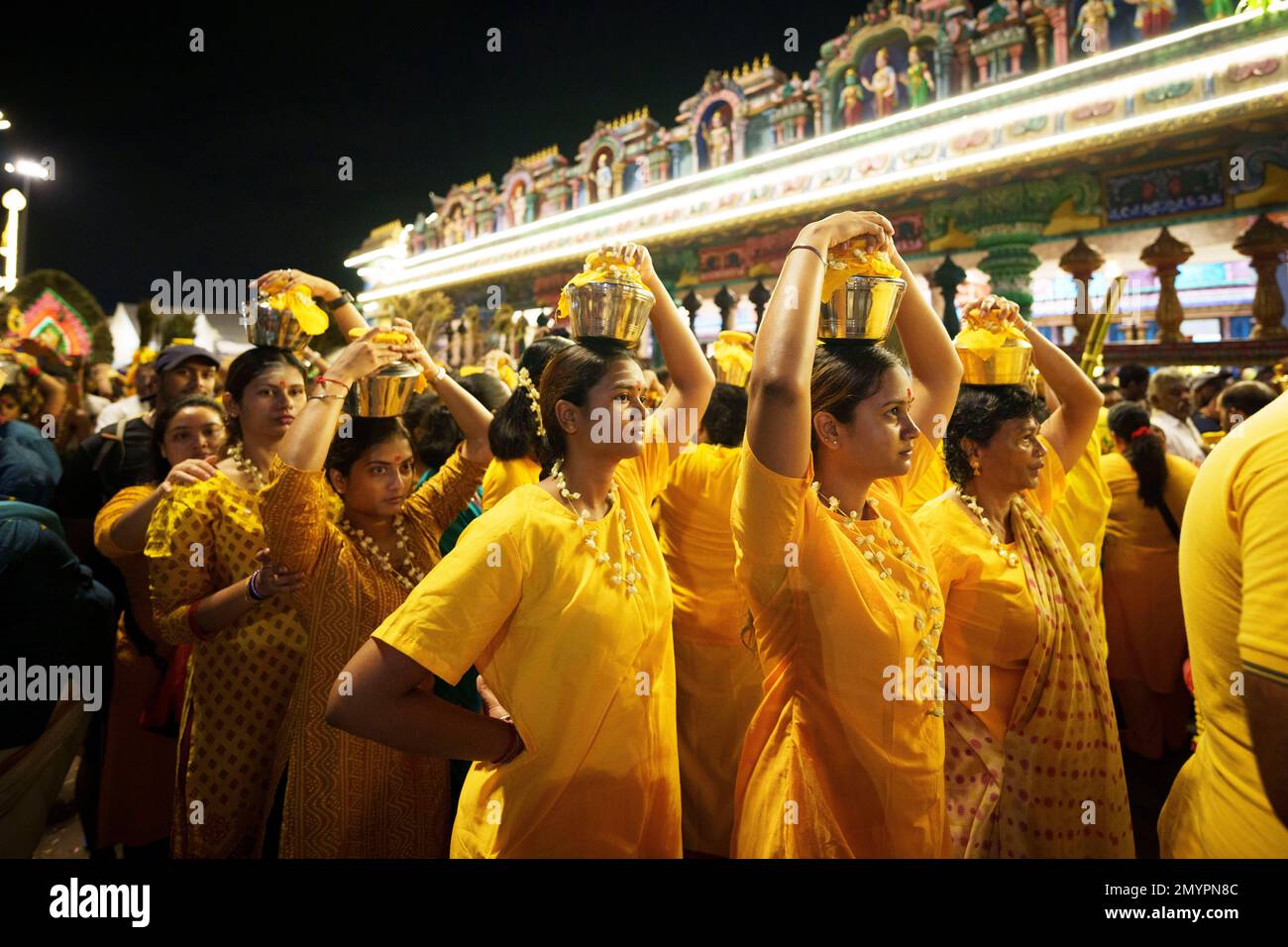 Hindu devotees carry milk pots in a procession walk towards Sri ...