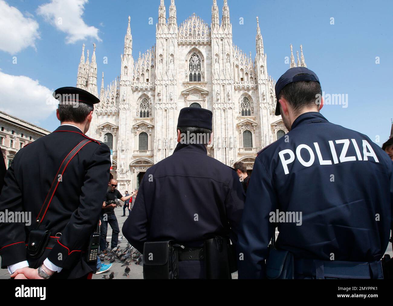 A Chinese Police officer, center, is flanked by Italian Police officers ...