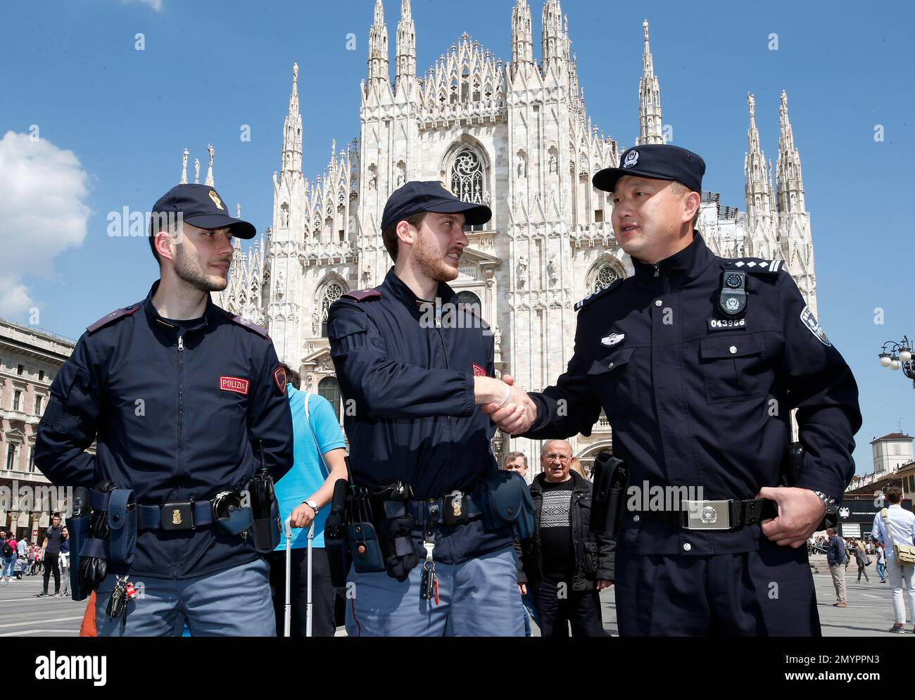 A Chinese Police officer, right, shakes hands with an Italian Police ...