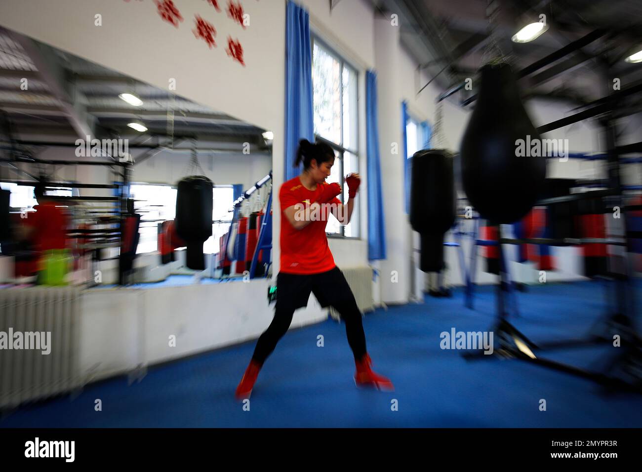 Chinese female boxer Li Qian practices her punch as she trains for the Rio 2016 Olympic Games at ...