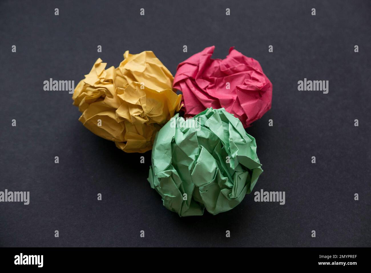 A colorful crumpled paper balls on a black background Stock Photo - Alamy