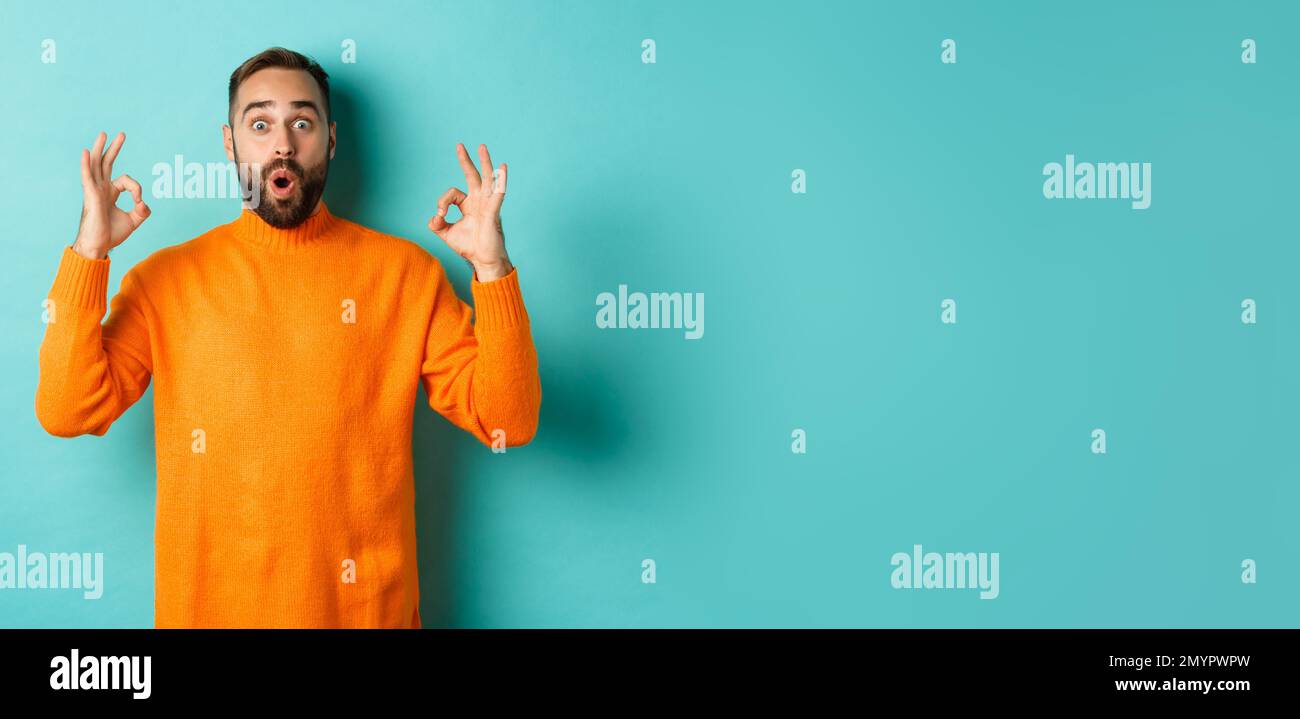 Impressed man praising something super cool, showing okay sign and ...