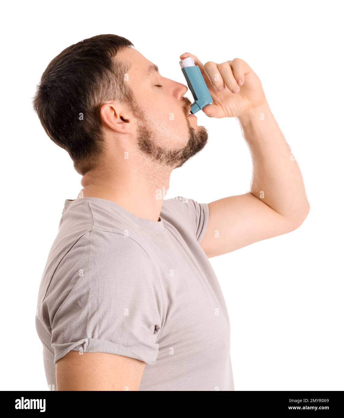 Sick man with inhaler on white background Stock Photo - Alamy