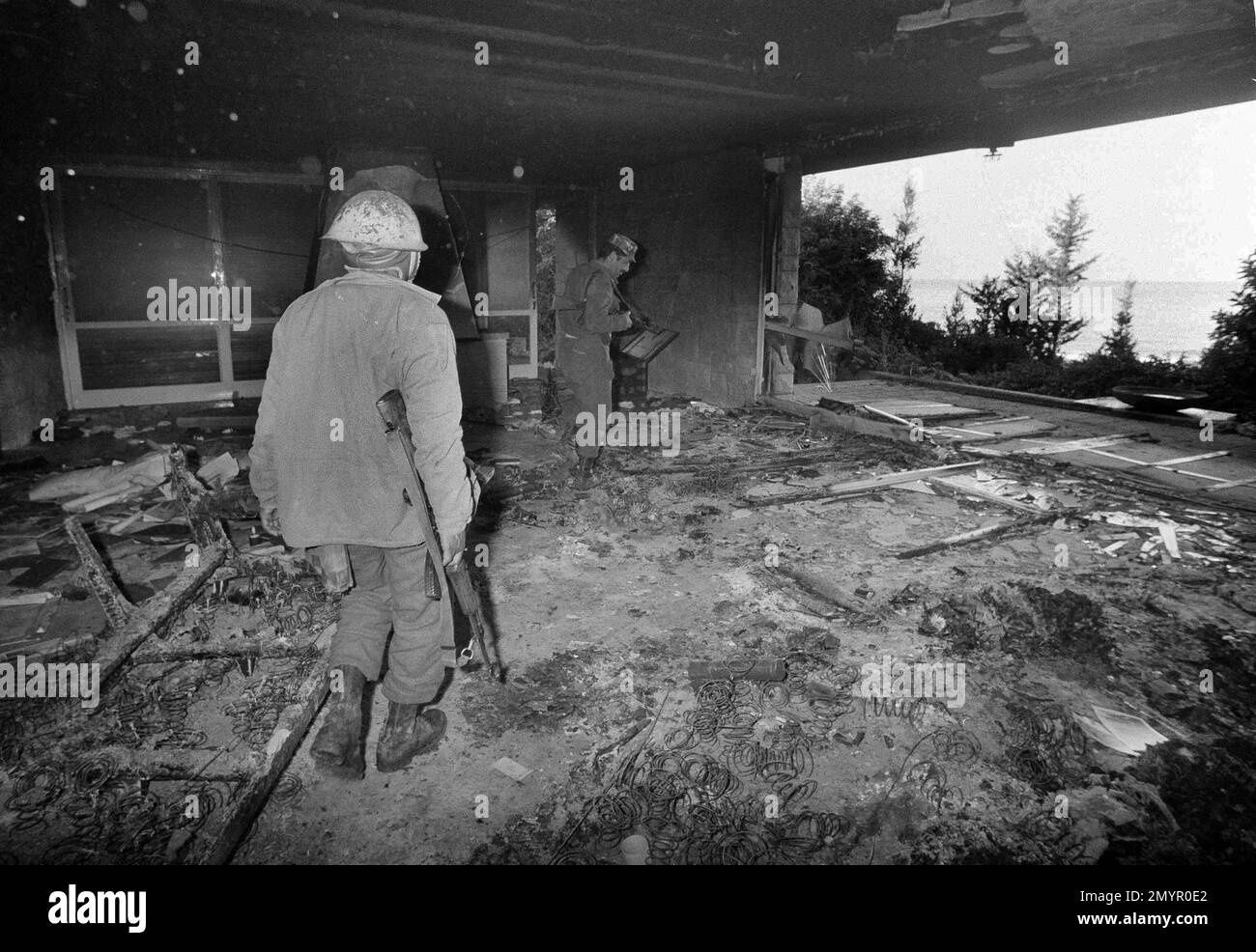 Palestinian Liberation Army troopers seen at the looted and burned ...