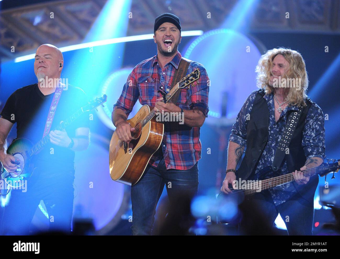 Michael Carter, from left, Luke Bryan, and James Cook perform during ...
