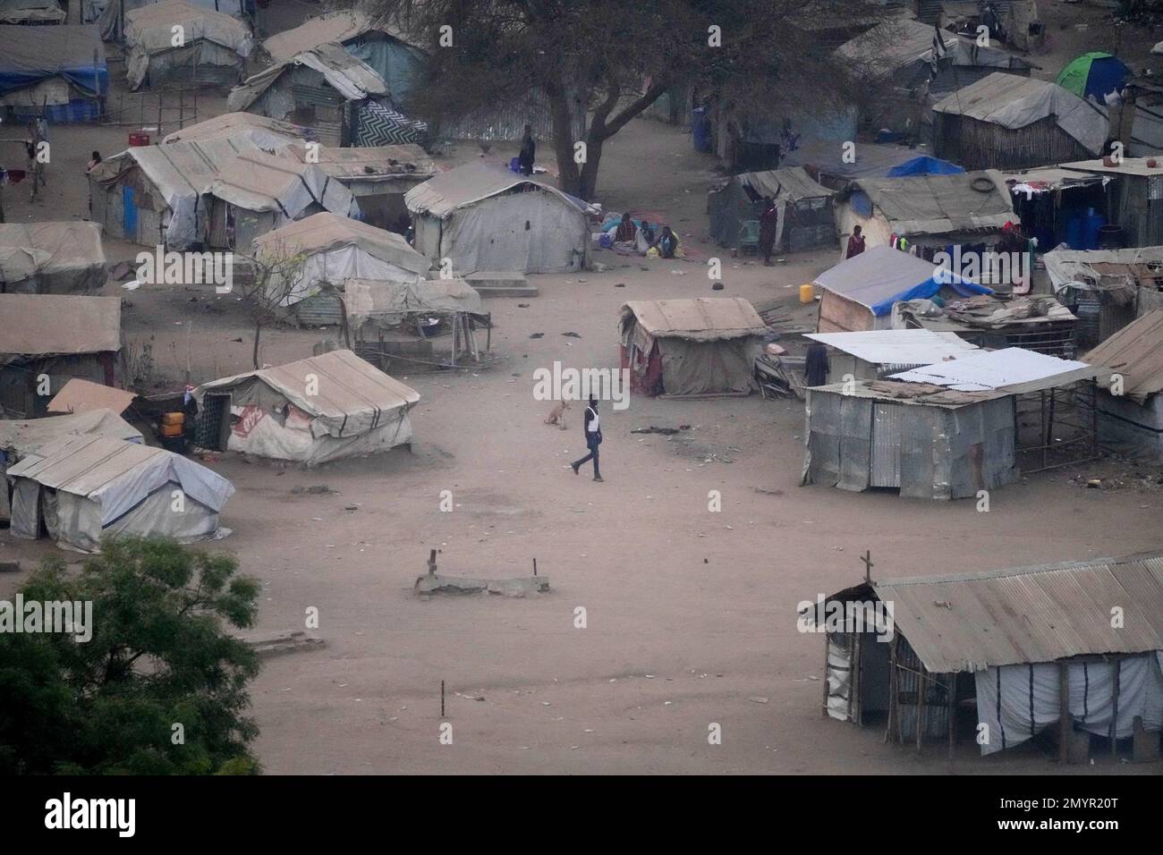 People stand by their houses in Juba, South Sudan, Sunday, Feb. 5, 2023 ...