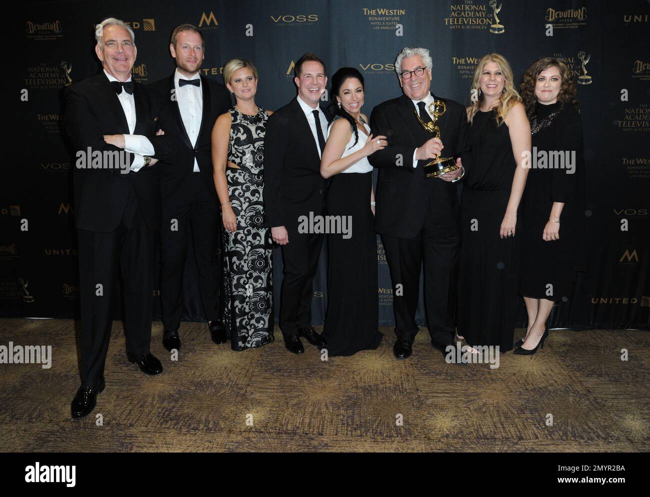 Gordon Elliott, left, and the crew of “The Chew” pose in the pressroom ...