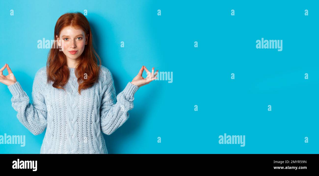 Smiling confident girl with red hair staying patient, holding hands in ...