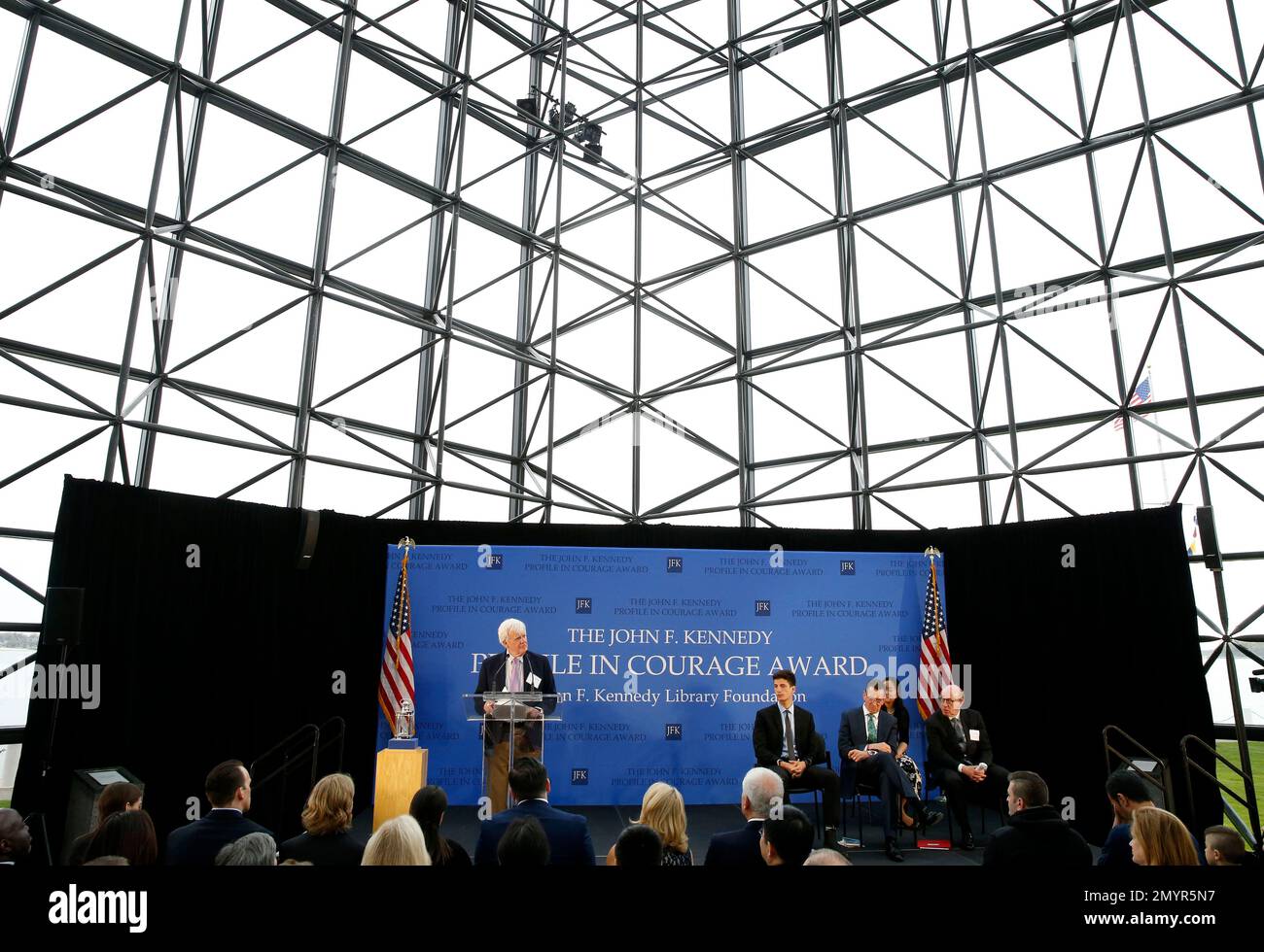 Albert Hunt, facing left, speaks during the John F. Kennedy Profile in ...