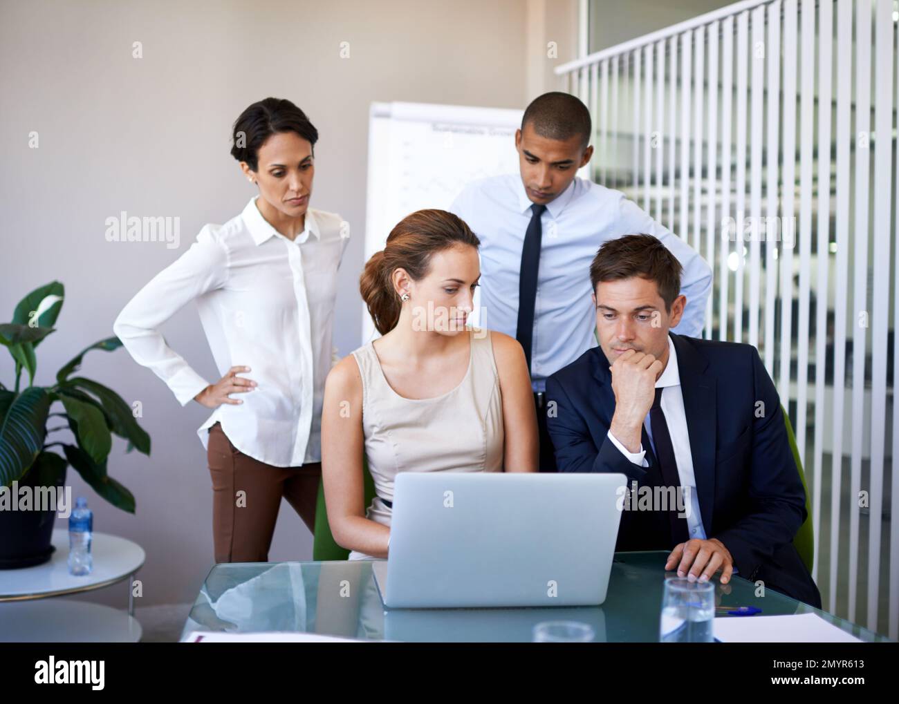 One intense brainstorming session. a group of businesspeople using a ...