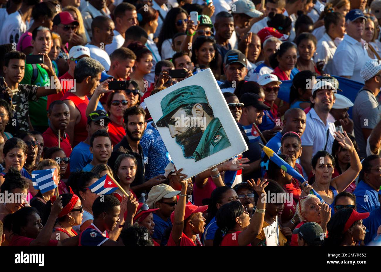 People with an image of the Cuban leader Fidel Castro march during the ...