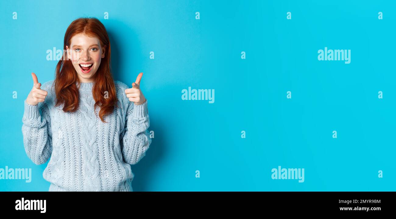 Cheerful teenage girl showing approval, make thumbs up and agree ...