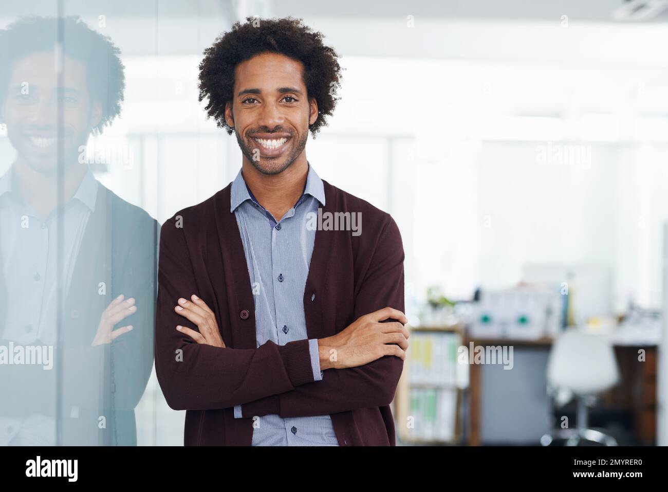 Keeping up morale in the workplace. Portrait of a businessman standing ...