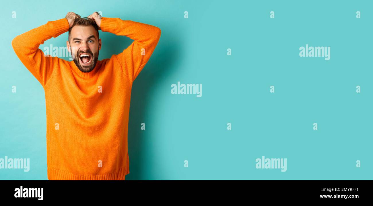 Frustrated man shouting, pulling out hair and screaming angry, losing ...