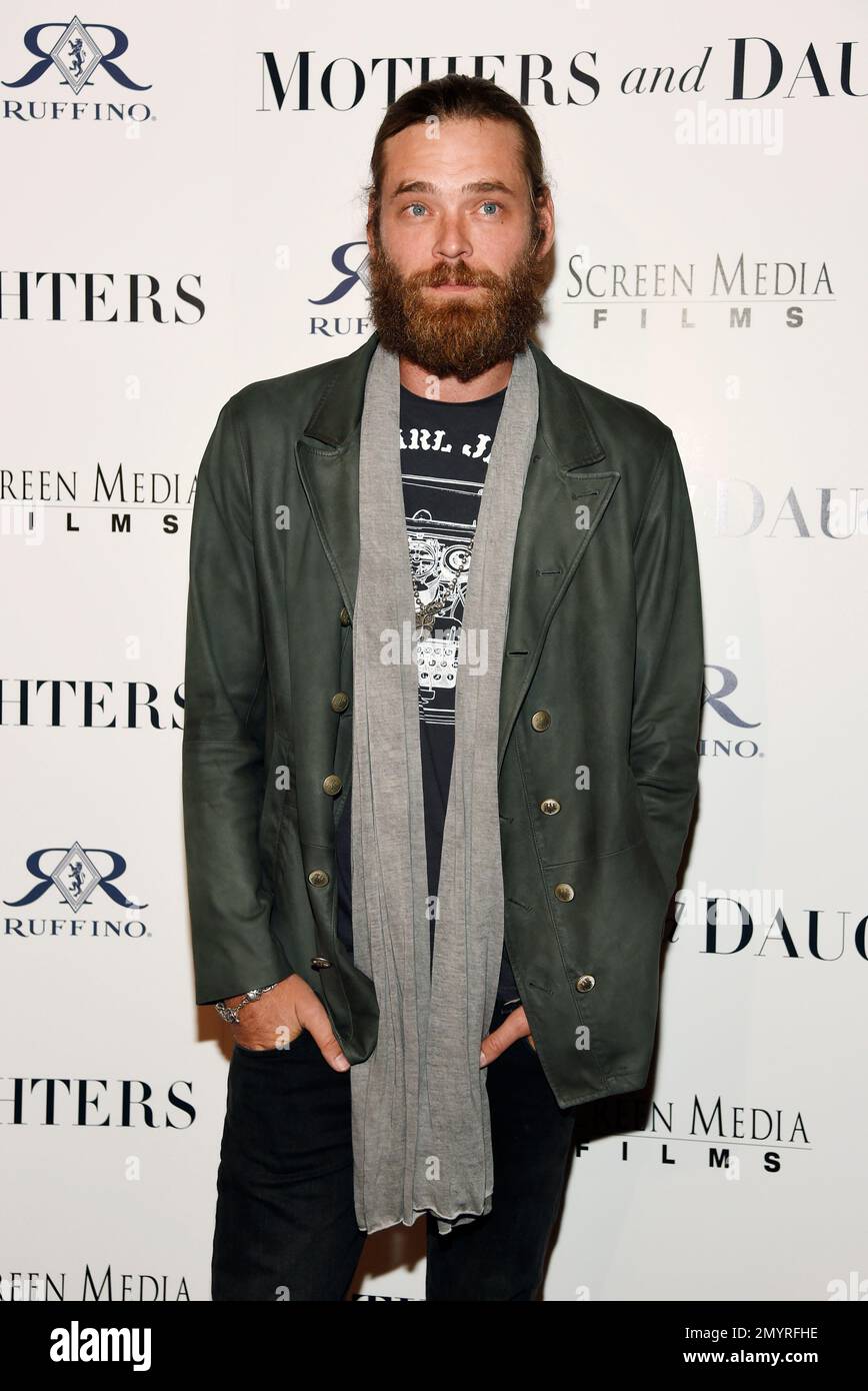 Christopher Backus poses at the premiere of the film "Mothers and ...