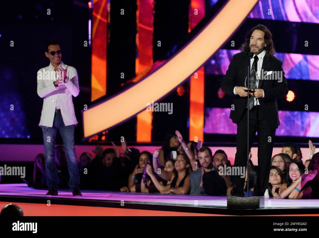 Singer Marc Anthony,left, applauds as Marco Antonio Solis receives the ...