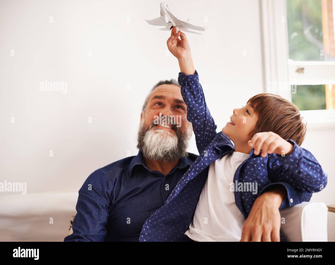 Fighter jet fun with grandpa. a young boy sitting on his grandfathers ...