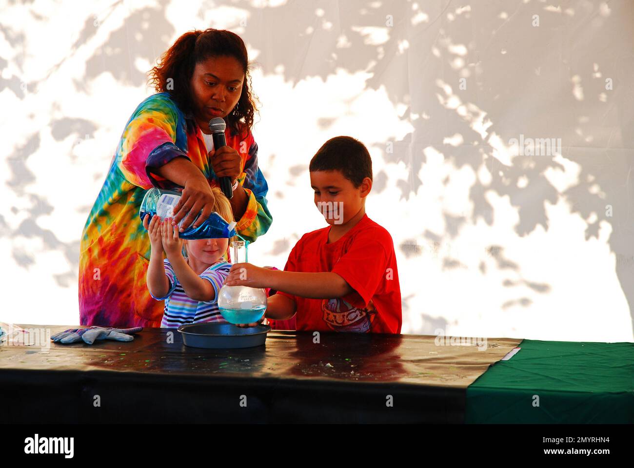A young boy and girl participate in a science experiment at a state ...