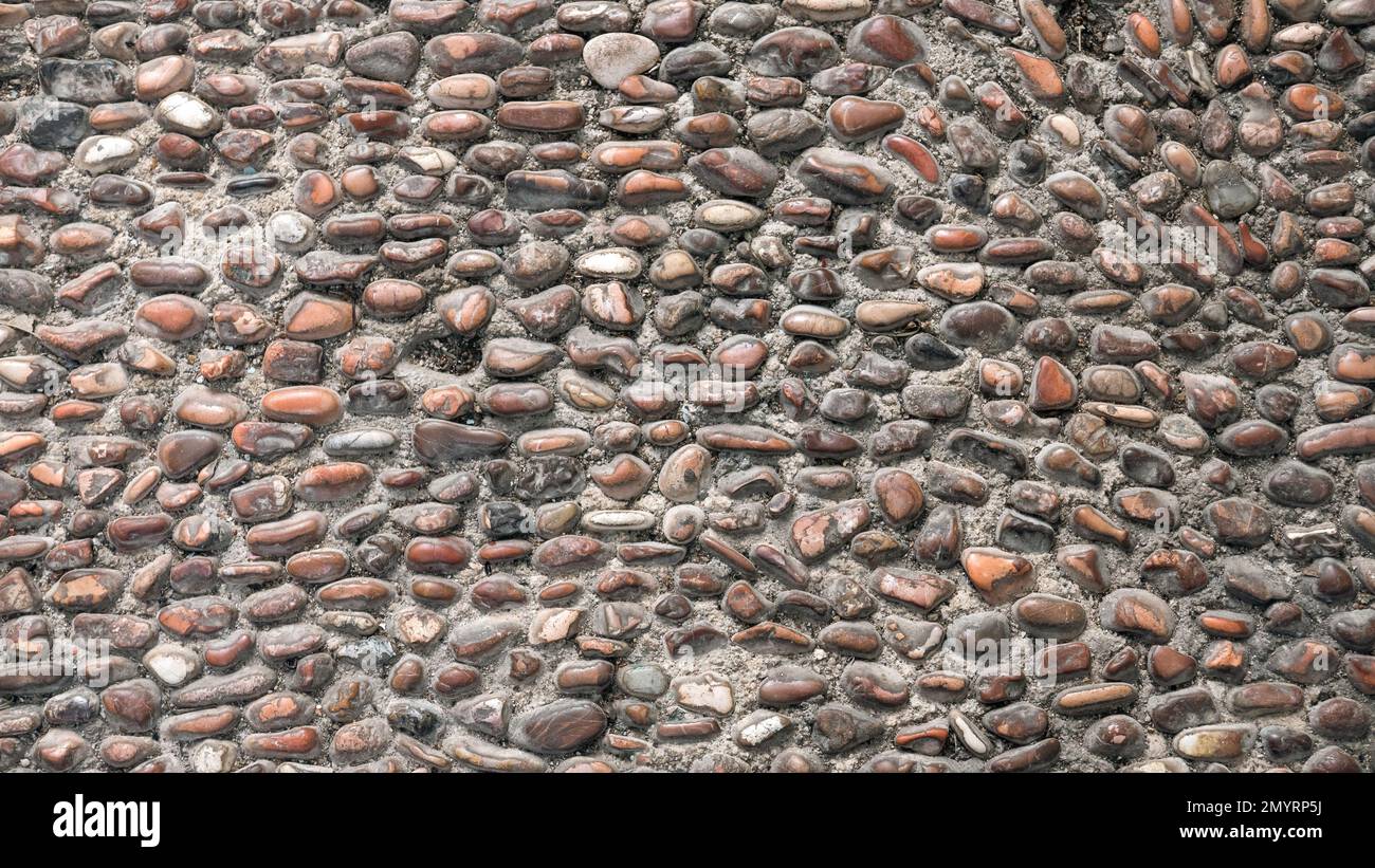 A Textured Cobble Pavement. Pebble stones on the pavement Stock Photo ...