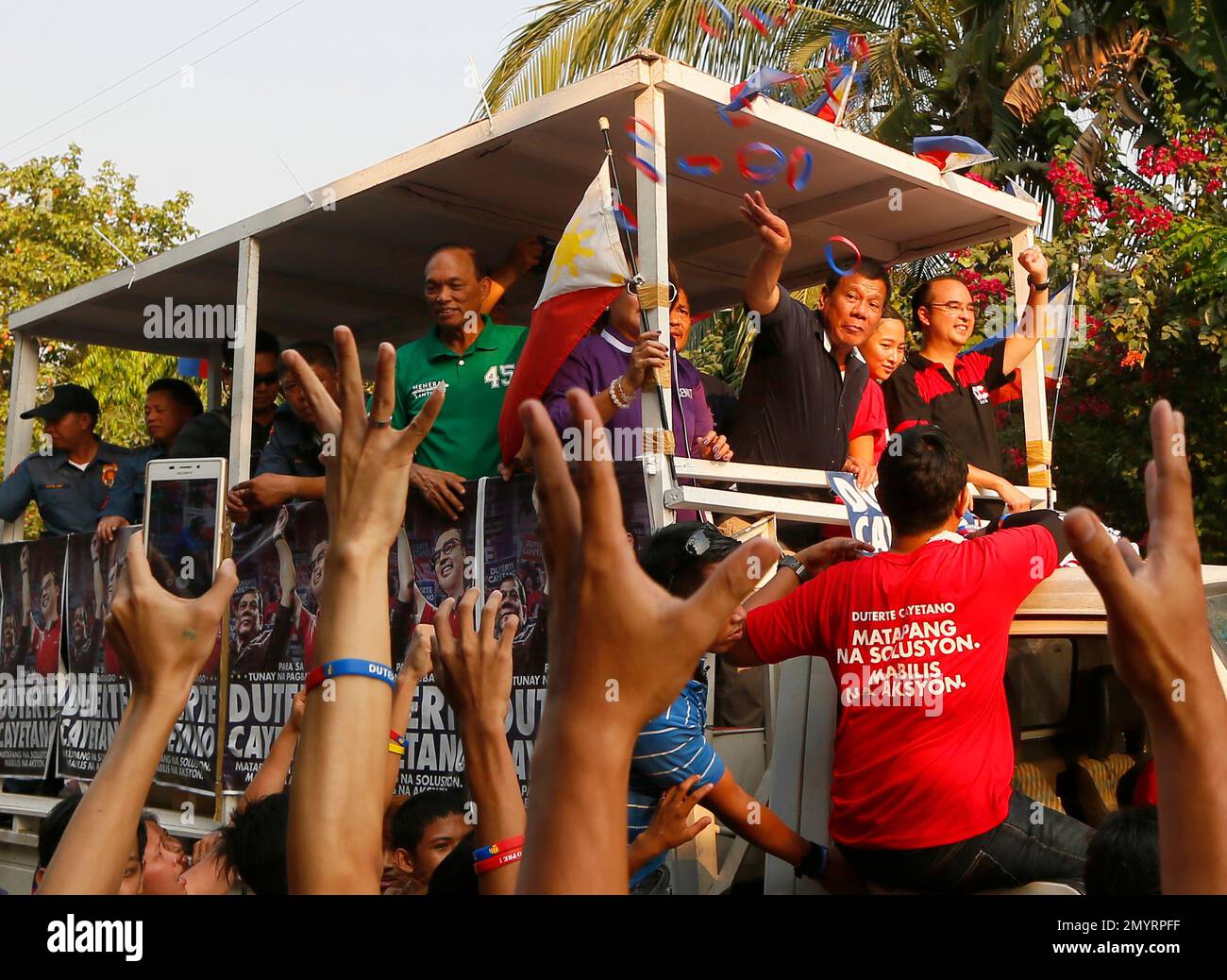 Presidential candidate Mayor Rodrigo Duterte, third right, throws ...