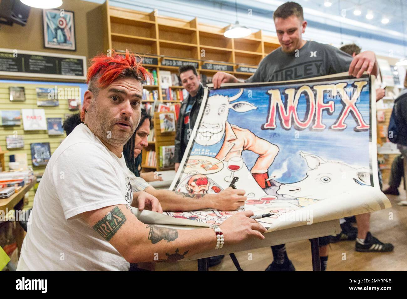 NOFX singer “Fat Mike” Burkett poses as he prepares to sign a fan's ...