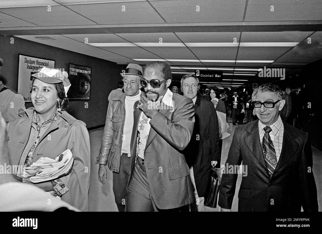 Boston Red Sox pitcher Luis Tiant, center, and his wife, Maria, walk ...