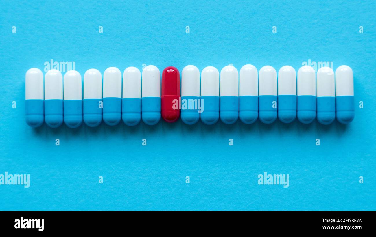 A row of medicine pills with a single red pill in the middle Stock ...