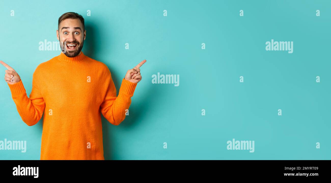 Shopping and advertisement concept. Excited man buyer pointing fingers ...