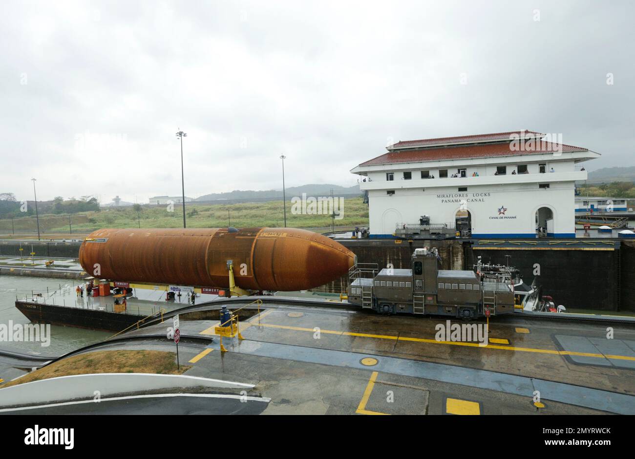 A tugboat and barge transporting NASA's only remaining space shuttle ...