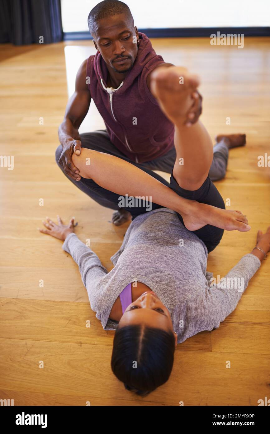 Helping to hone those stretching skills. a dance instructor helping his ...
