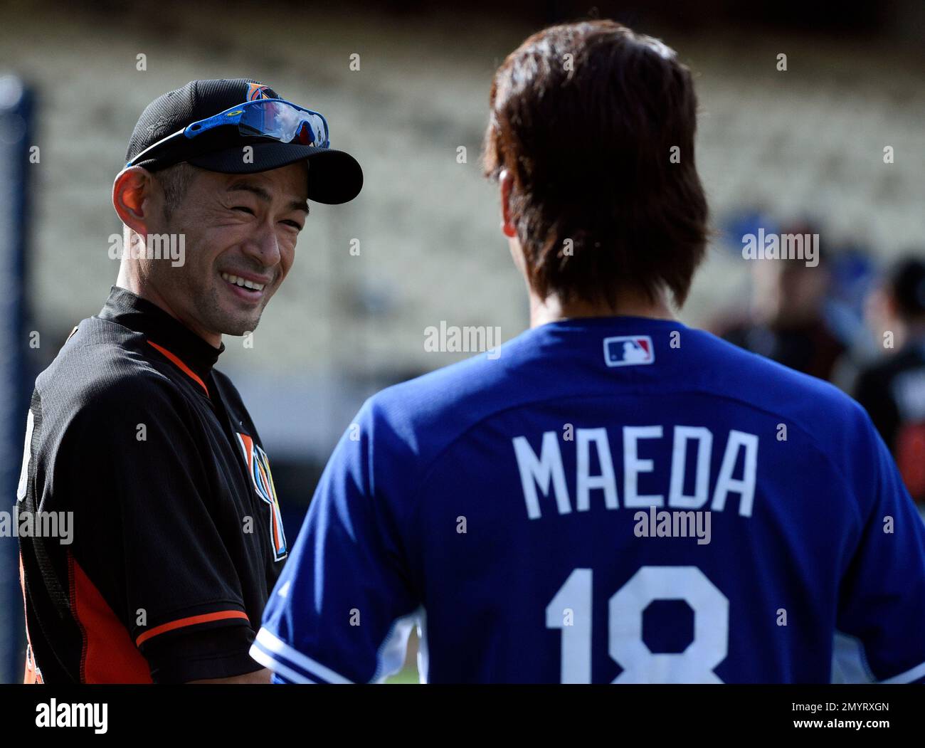 Miami Marlins' Ichiro Suzuki, left, of Japan talks with Los Angeles Dodgers' Kenta Maeda, right ...