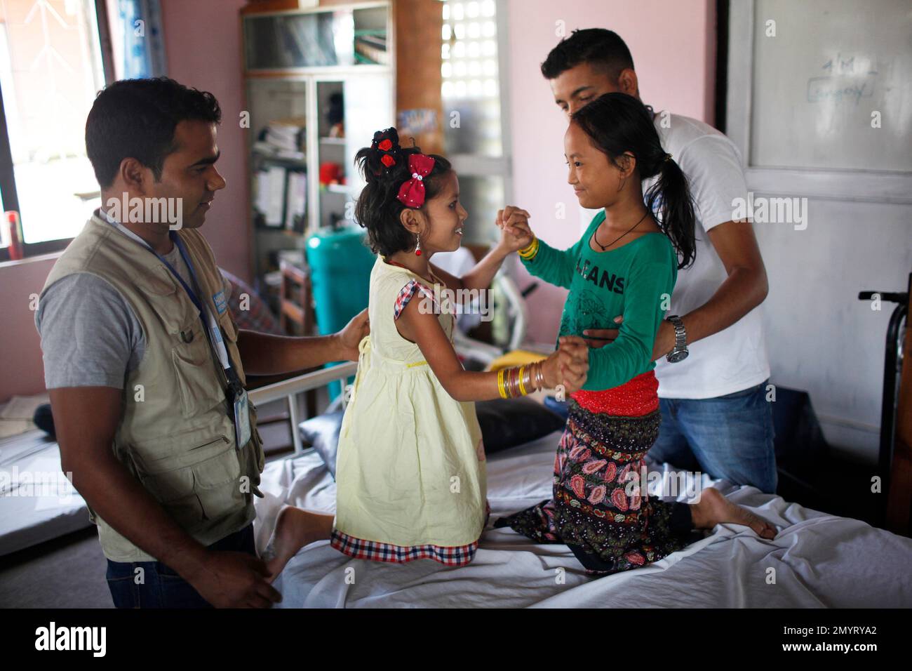 In this Oct. 5, 2015 photo, amputee victims Khendo Tamang, right and Nirmala Pariyar, both 8 ...