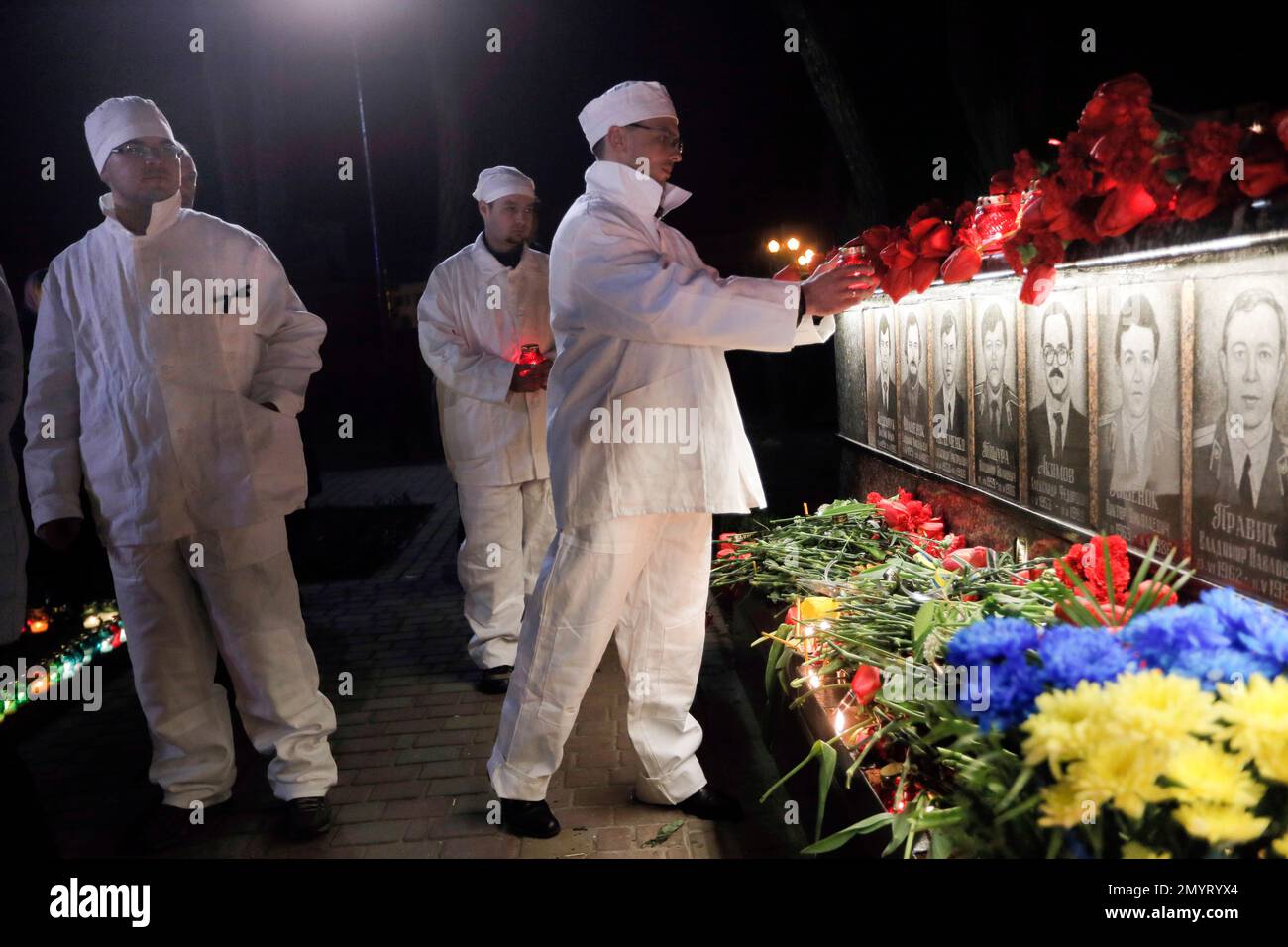 The Chernobyl nuclear plant workers in uniform attend a ceremony to ...
