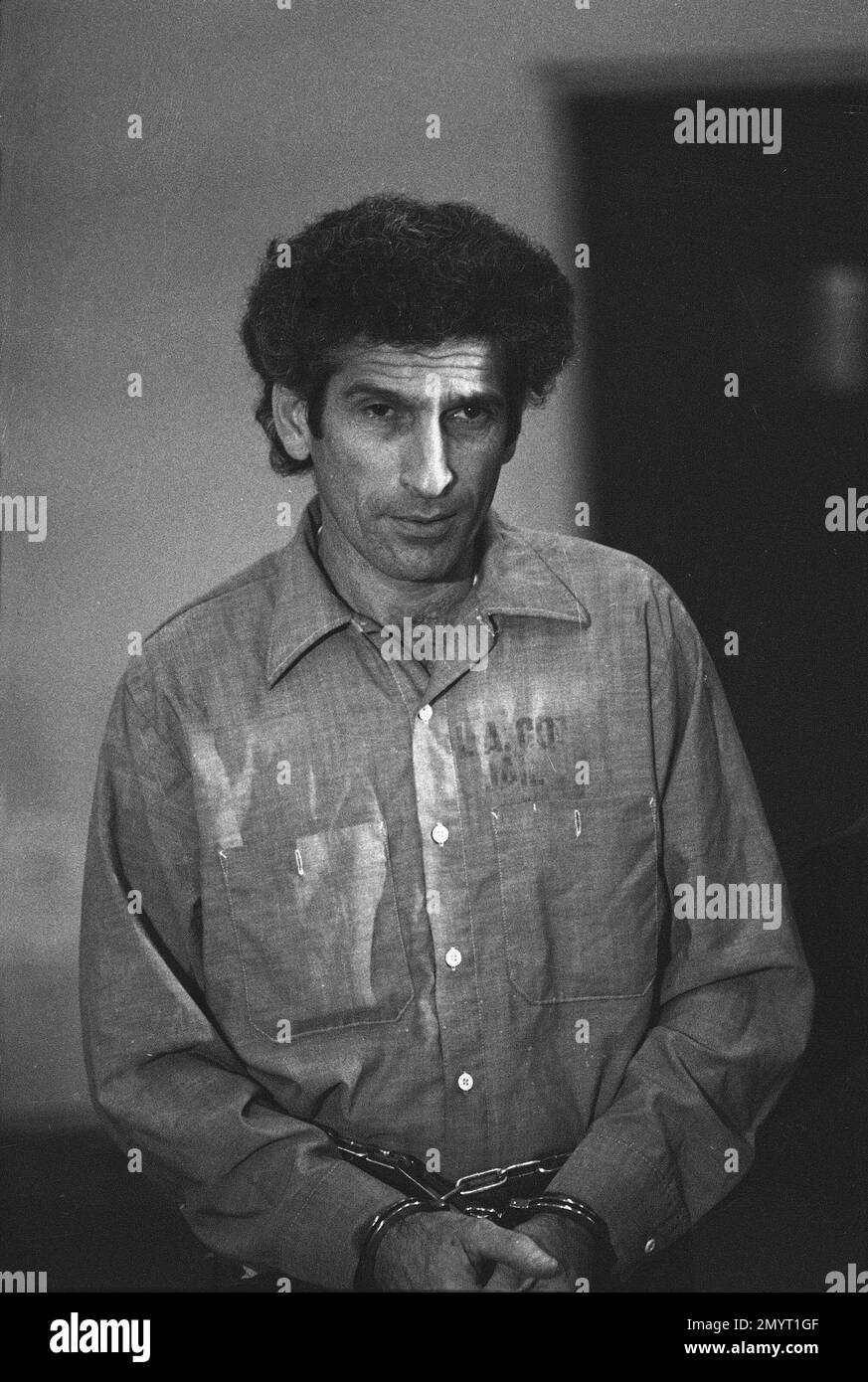 Angelo Buono, his hands manacled, leaves Los Angeles court building ...