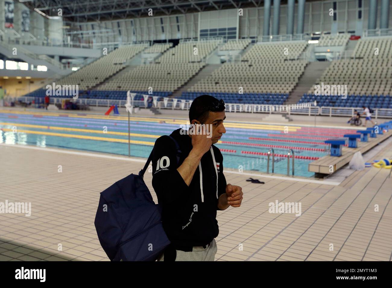 Syrian Ibrahim Al-Hussein speaks on his cell phone before a training ...