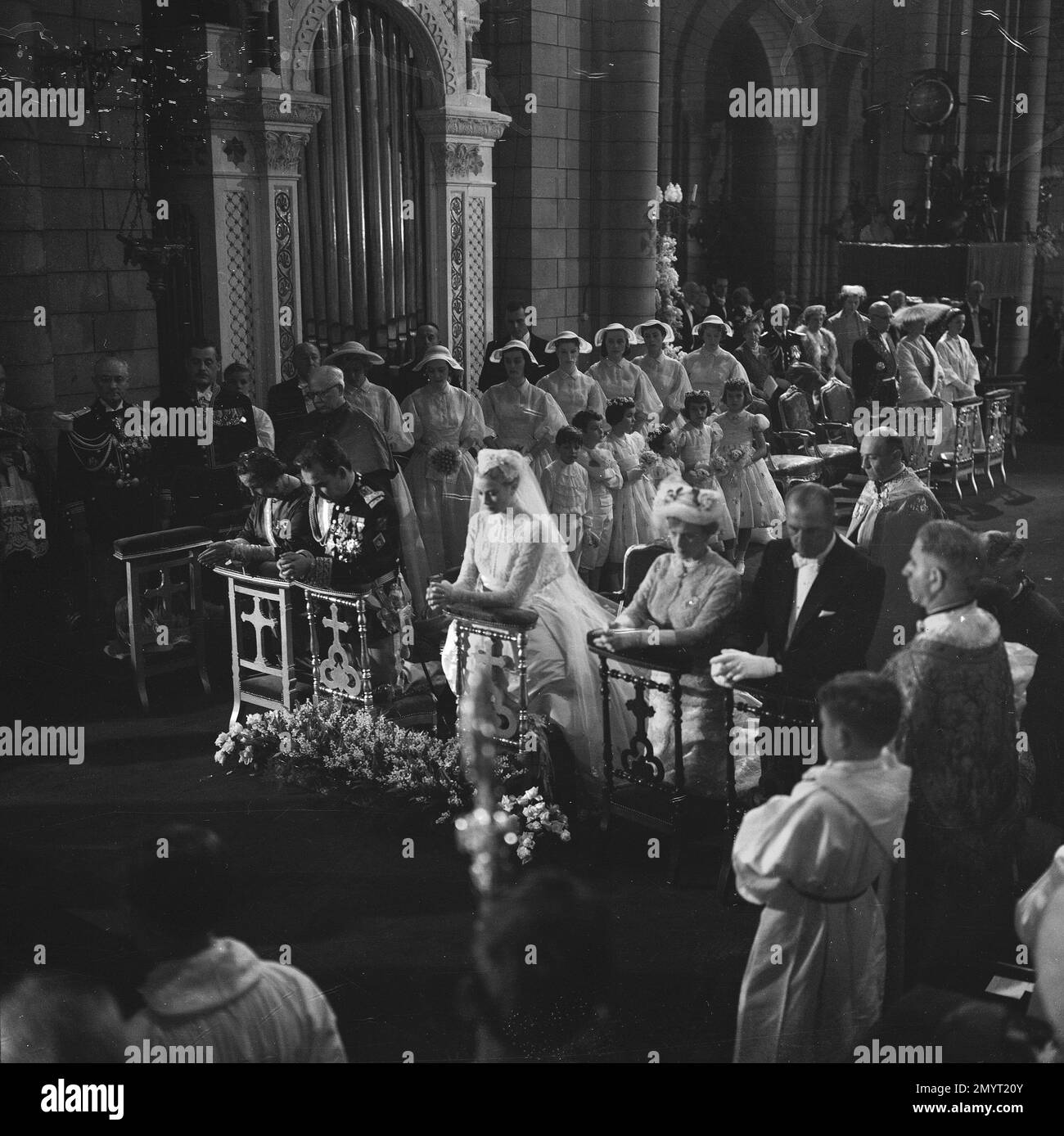 Prince Rainier III and Grace Kelly pray during their wedding ceremony ...