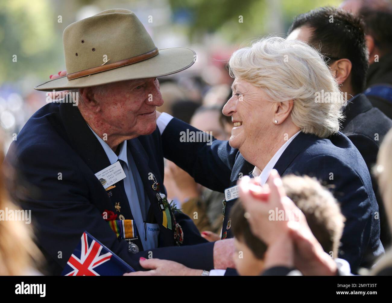 A war veteran embraces a friend in the crowd as he marches in the ...
