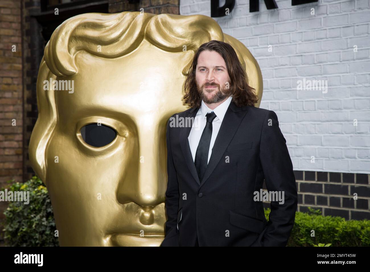 Kieran Bew poses for photographers upon arrival at the British Academy ...