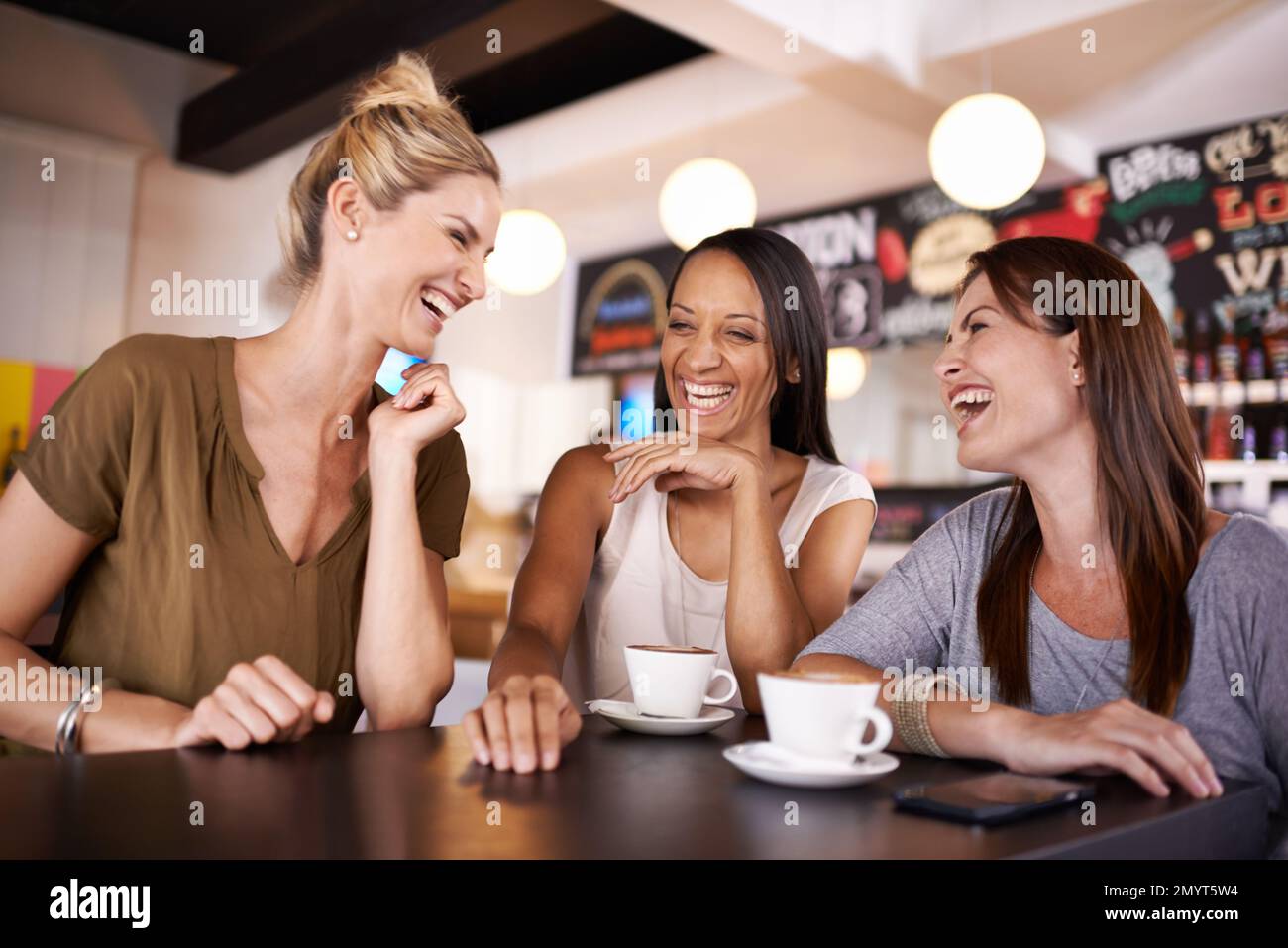 This is why were friends. three friends having fun at a coffee shop ...