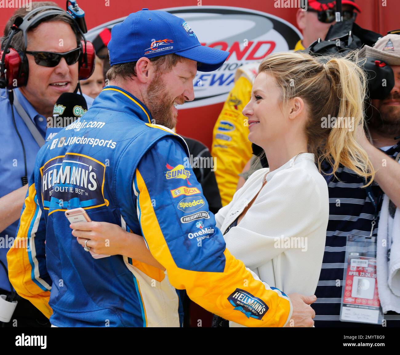 Dale Earnhardt Jr. ,left, gets a hug from his fiancee Amy Reimann as he ...