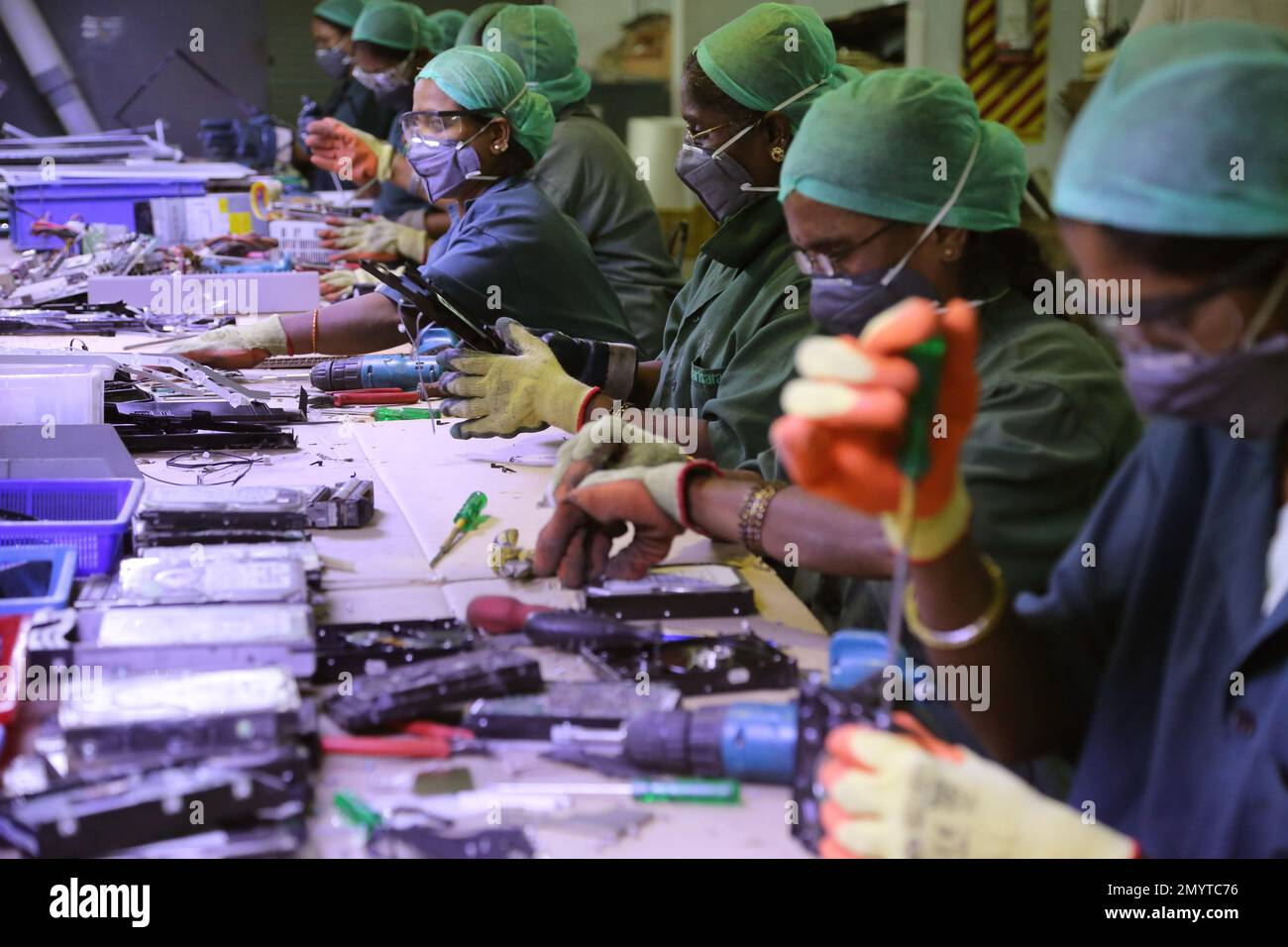 Indian women workers dismantle electronic waste at an electronic waste ...