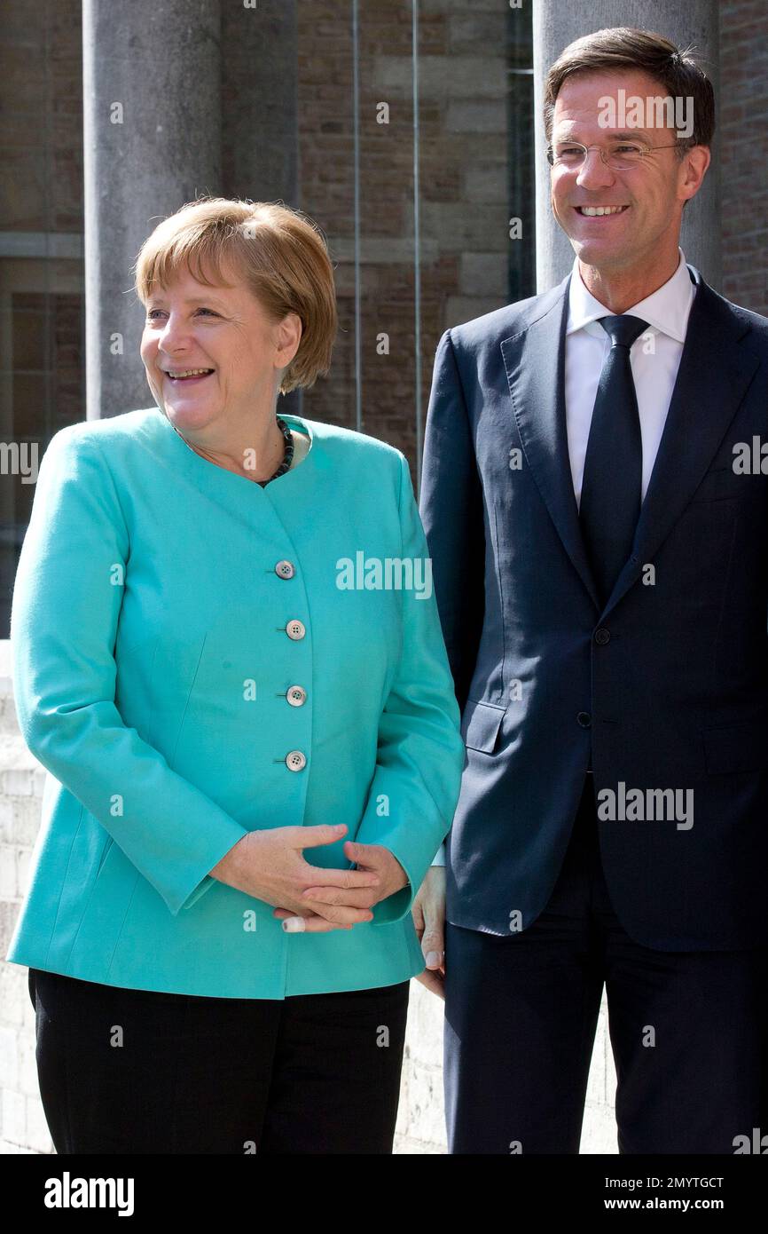 German Chancellor Angela Merkel, left, poses with Dutch Prime Minister ...