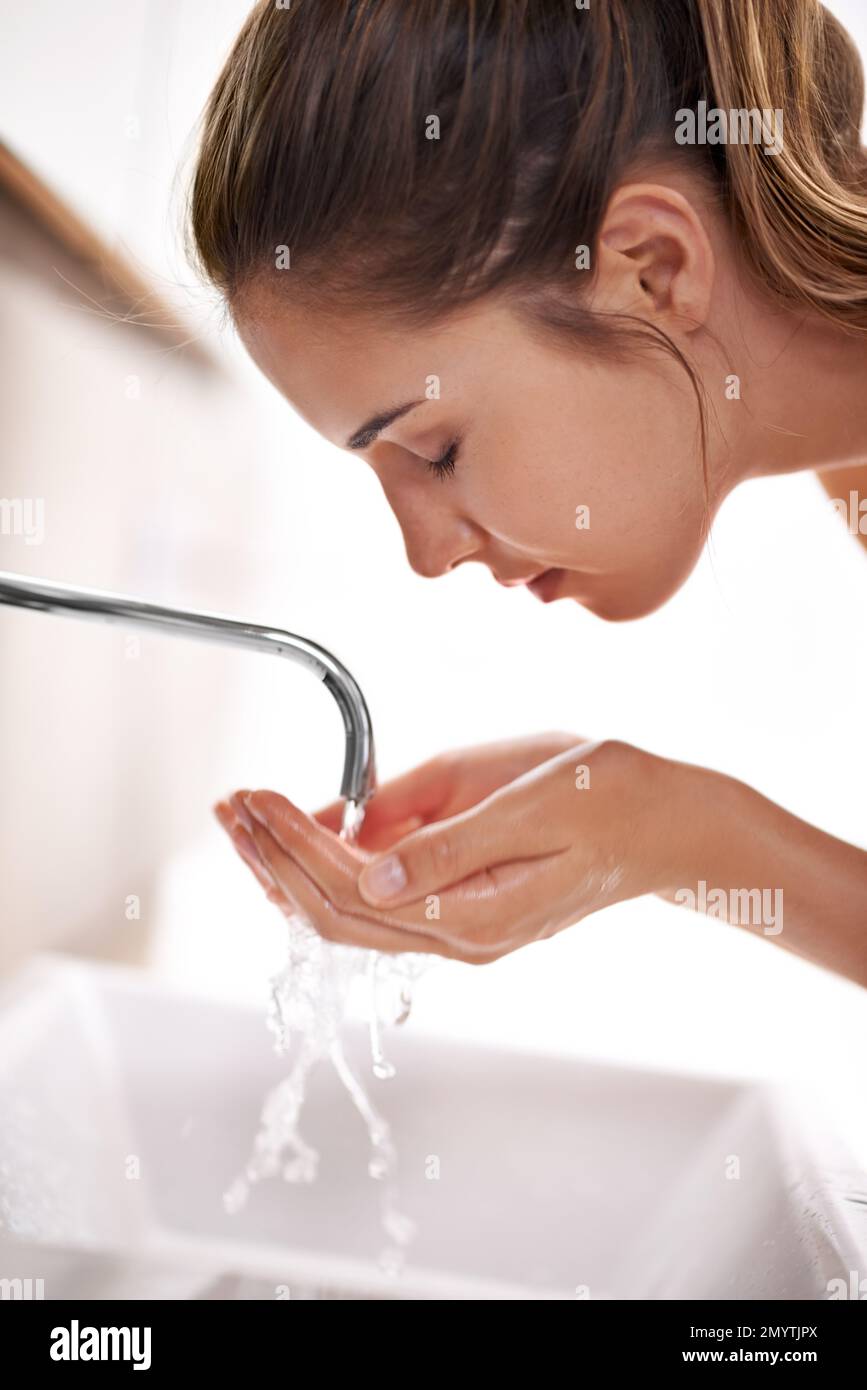 Beautiful skin begins with washing. Closeup shot of a young woman ...
