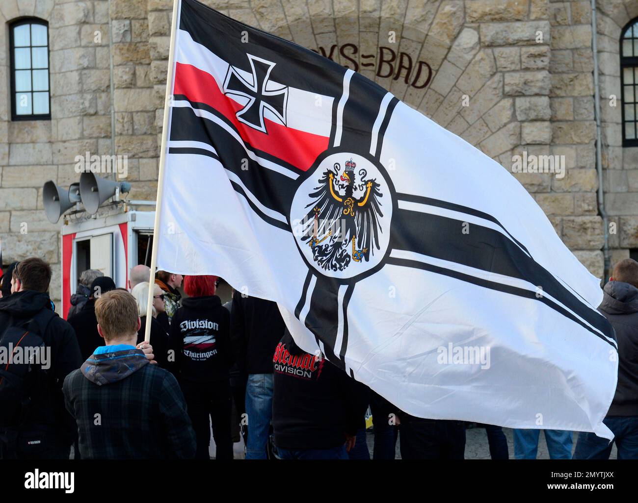 A demonstrator holds a German Imperial War Flag during a demonstration ...