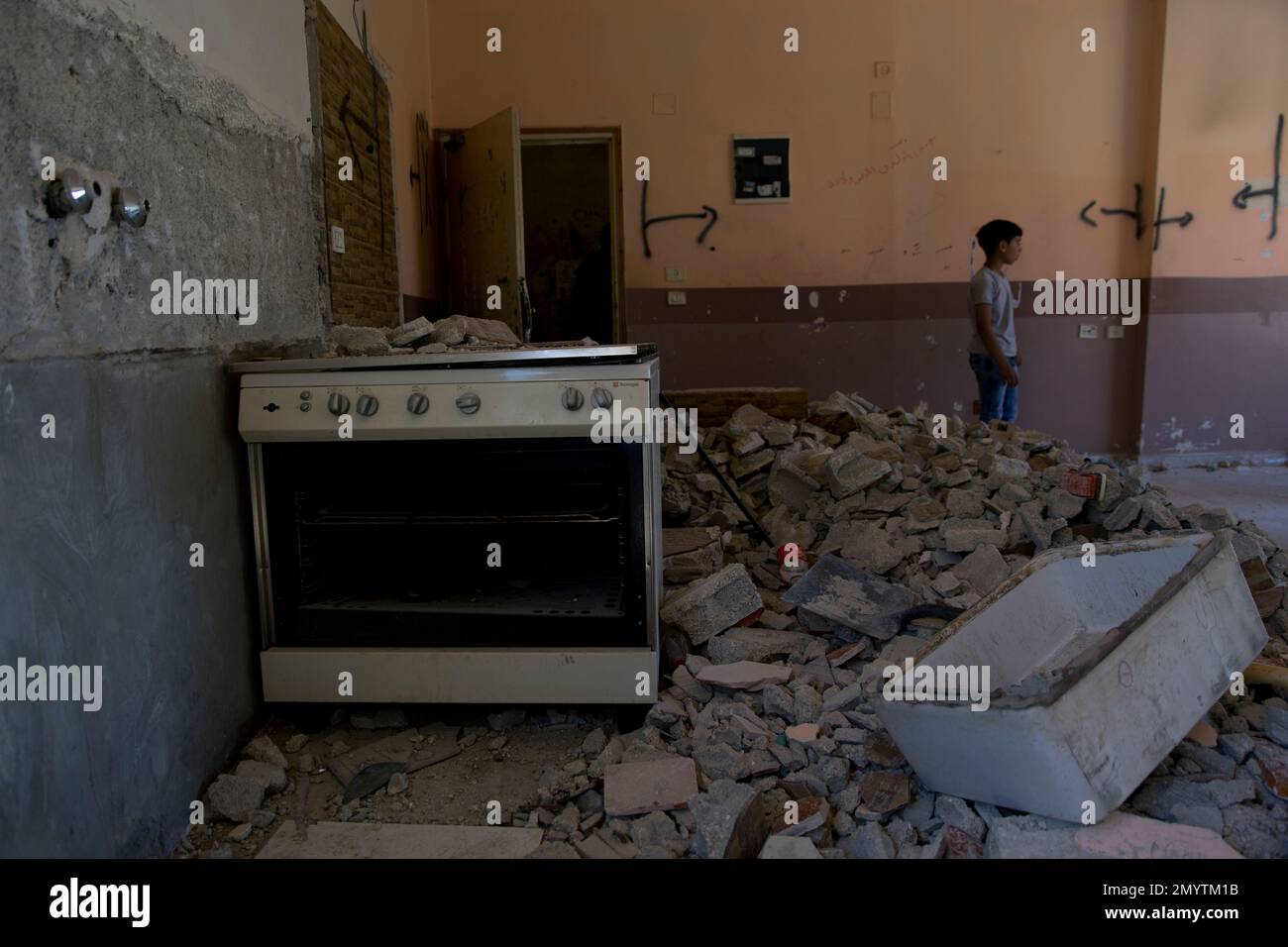 A Palestinian boy inspects the damaged house of Hussein Mohammed Abu ...