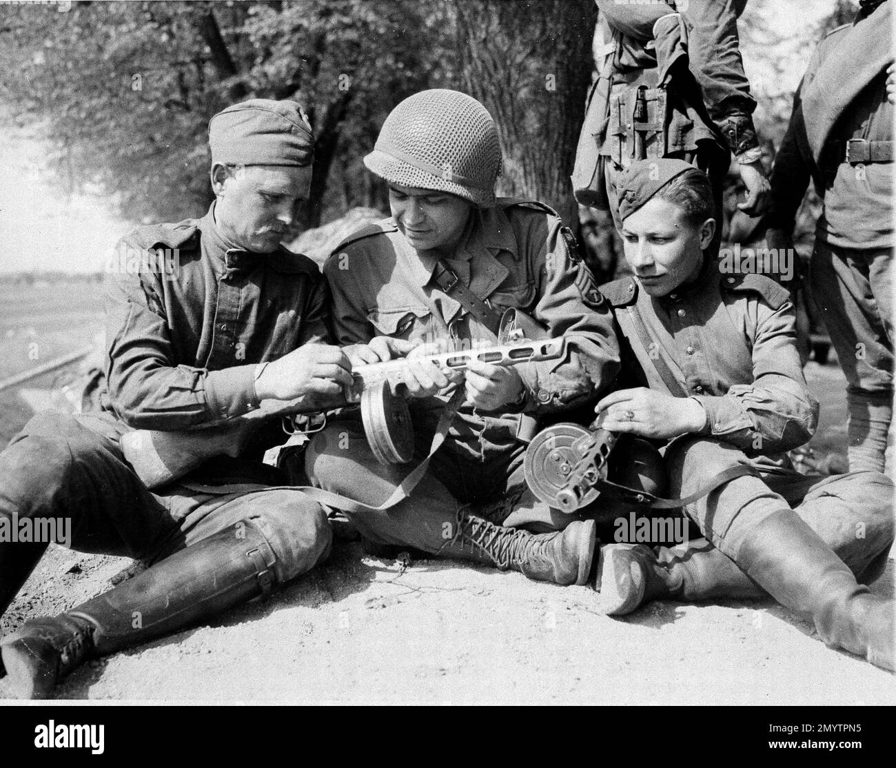 Sgt. Jose K. Tofete, center of San Pedro, Calif., examines the weapons ...