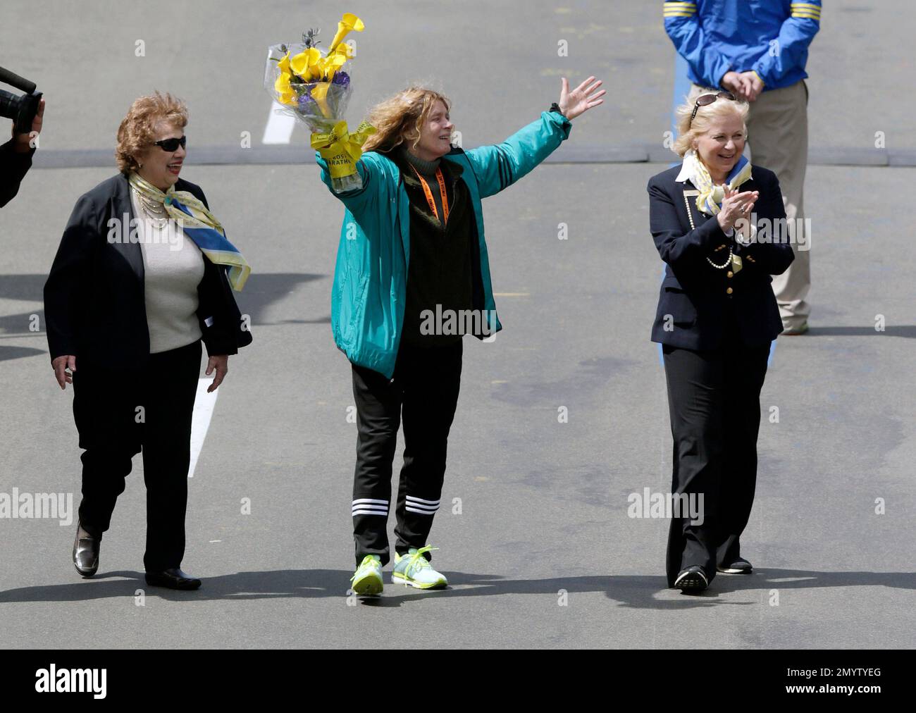 Bobbi Gibb, first woman to run the Boston Marathon in 1966, waves to the crowd at the finish ...
